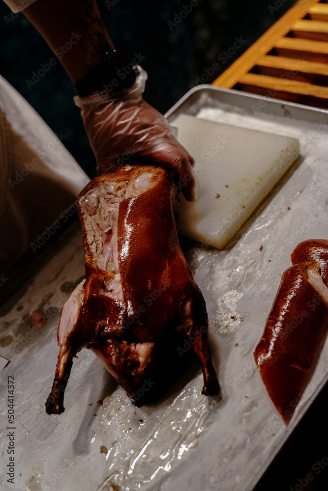 Chinese cook prepares Peking Roast Duck. Peking Duck is a famous duck ...