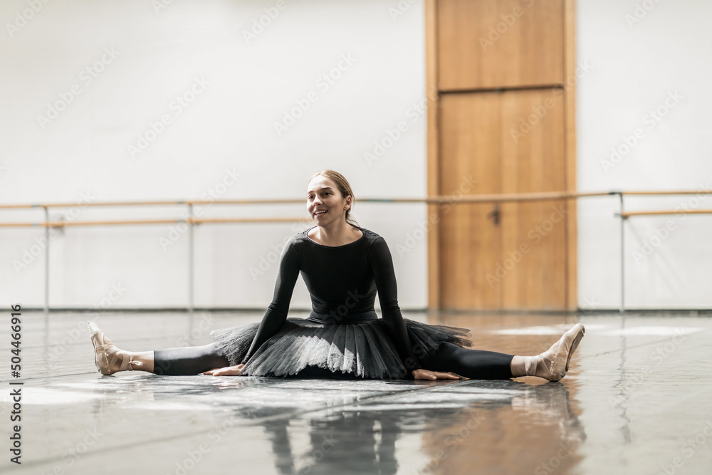 Female ballet dancer posing inside dance hall Stock Photo | Adobe Stock