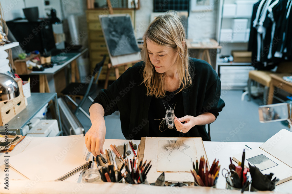 Female illustrator choosing pencil for drawing Stock Photo | Adobe Stock