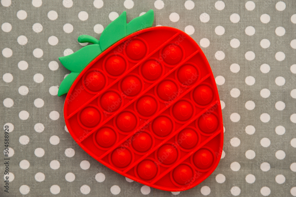 Sensory fidget toy "Pop-it". Instrument for fine motoric skils, tool to ...