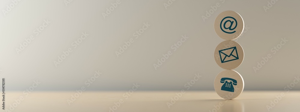 Wooden round telephone, envelope letter and e-mail symbols stacked on ...