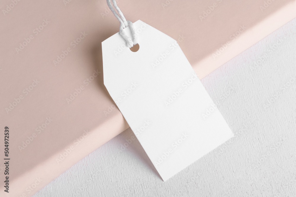 Rectangle white gift tag mockup with white cord, close up on beige and ...