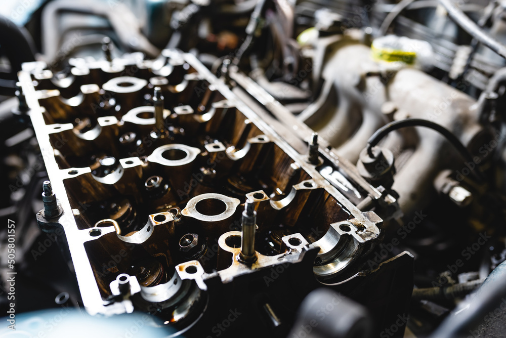 Disassembled car engine in oil. Cylinder head of an automobile engine ...