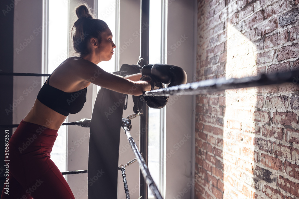 Side view of caucasian young female boxer contemplating while standing ...