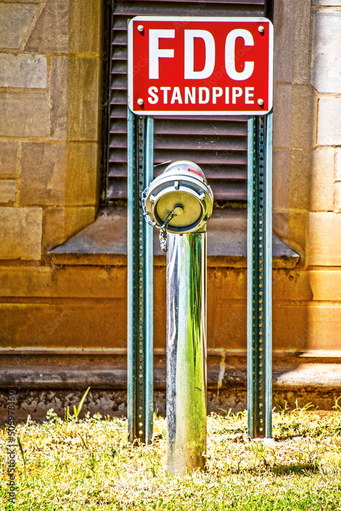 Стоковое фото «FDC Fire Department Connection Standpipe by old rock ...