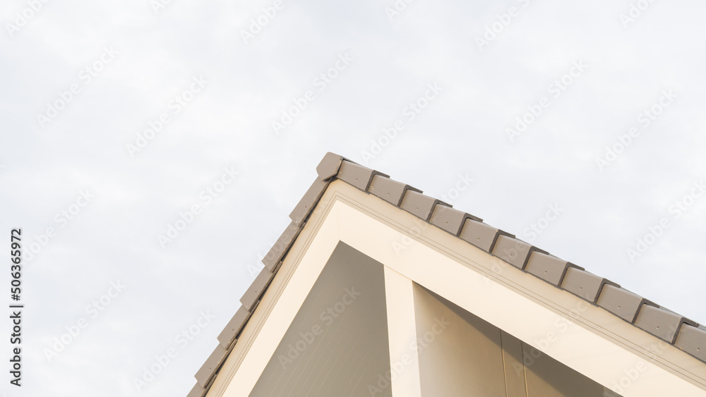 close-up, low angle shot, top corner of a gable roof, of a modern house ...