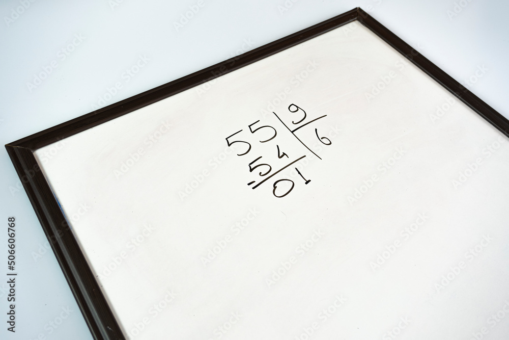 Division calculation with black color marker on whiteboard, math idea ...
