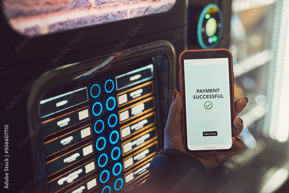 Consumer paying for product at vending machine using contactless method ...