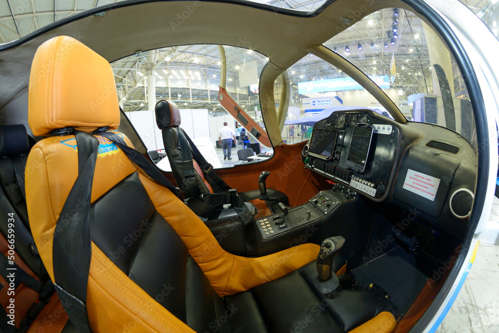 Cockpit of a light sport plane dashboard, steering wheel, pilot and ...