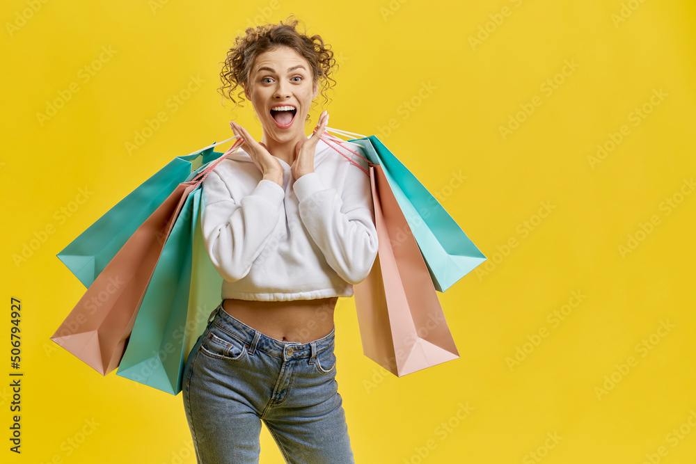 Front view of beautiful young model doing shopping. Slim girl with ...
