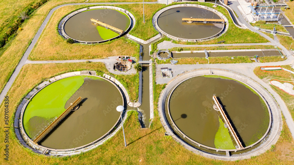 Aerial view of the tanks of a sewage and water treatment plant enabling ...