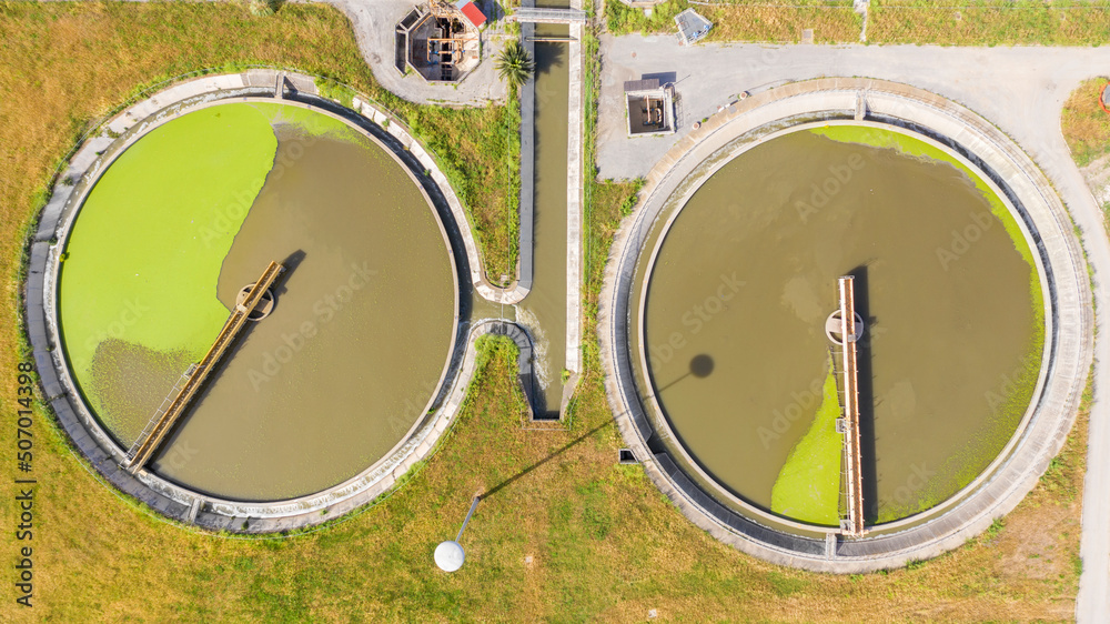 Aerial view of the tanks of a sewage and water treatment plant enabling ...