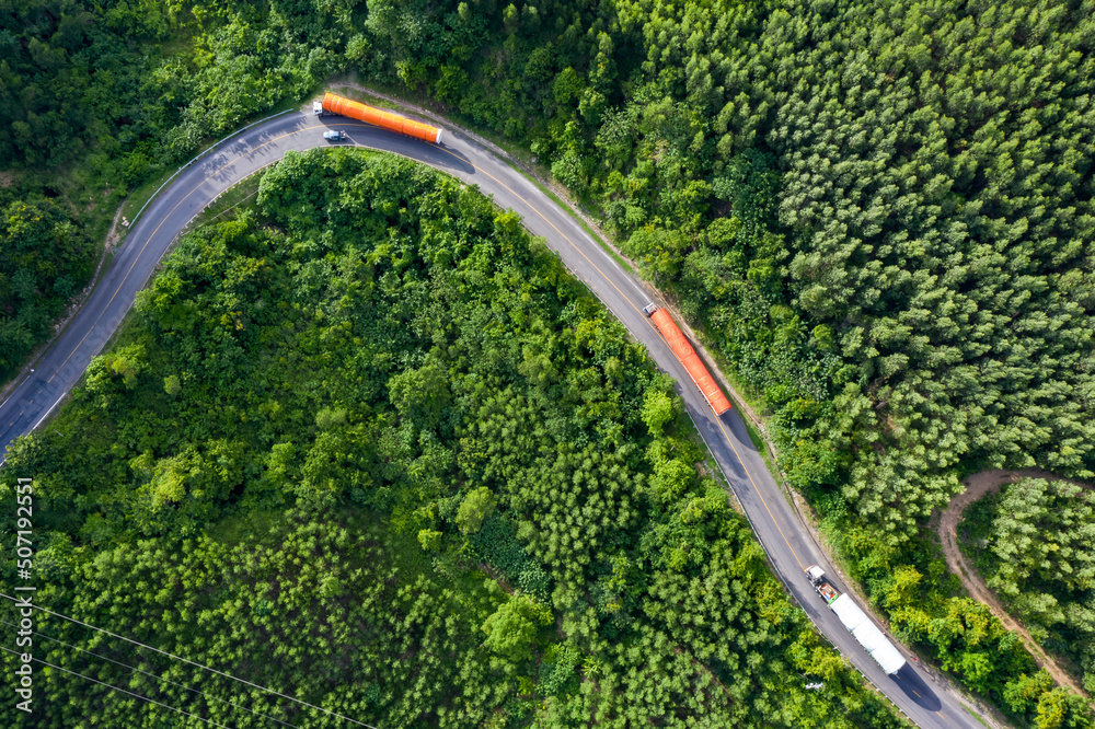 Transporting wind turbine propeller through curvy jungle road. Clean ...