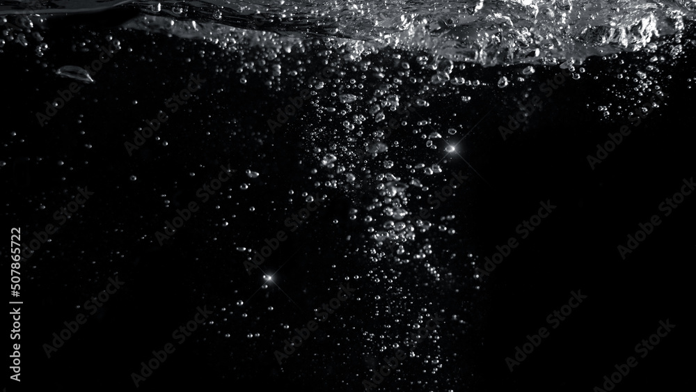 Blurred images of close-up soda water bubbles fizzing up or splashing or sparkling like a ...