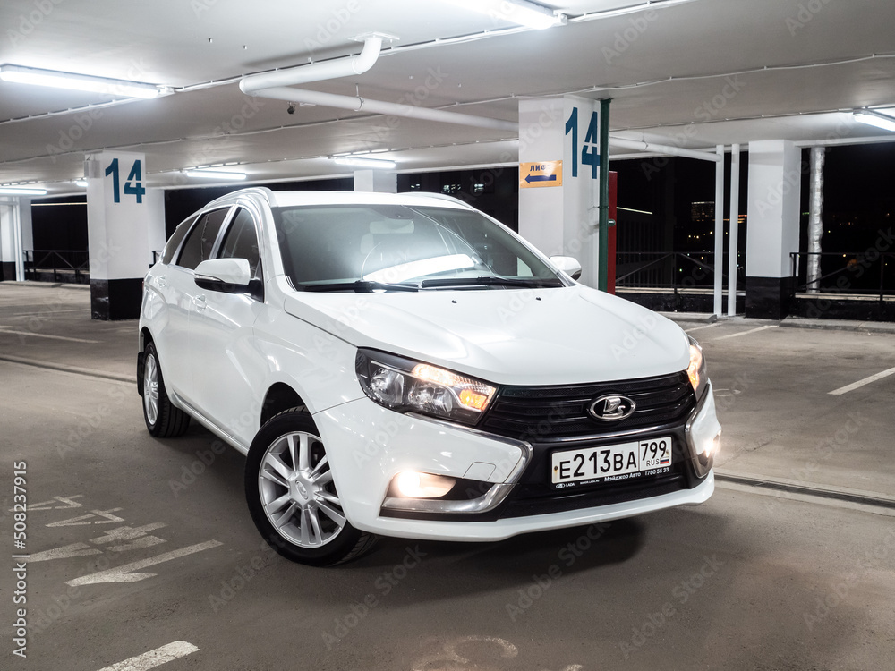 Photo Stock Modern beautiful Russian car Lada Vesta SW. A white station wagon in an empty multi ...