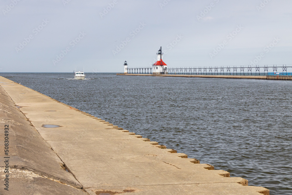 Fishing boat in the channel at St. Joseph North Pier Inner Lighthouse ...