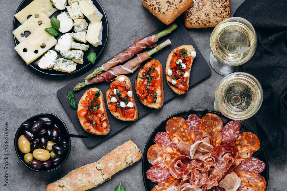 Food antipasto prosciutto ham, salami, olives and bread sticks and ...