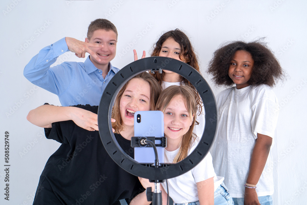 Four Teen girls and one boy smiling and shoots a video. selfies. The ...