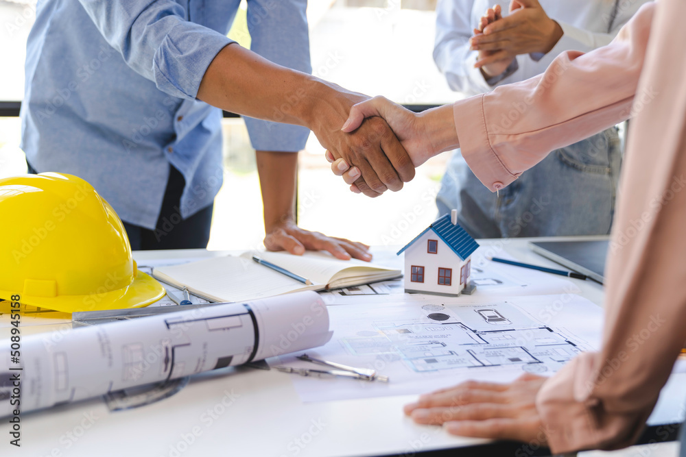 Architect and engineer construction workers shaking hands after ...