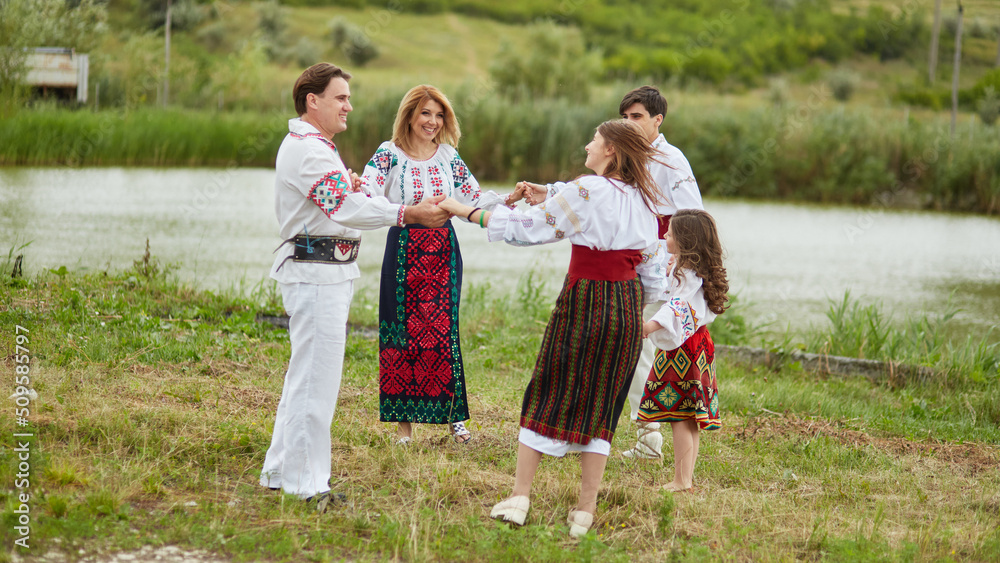 Full length image of a family with kids in traditional romanian dress ...