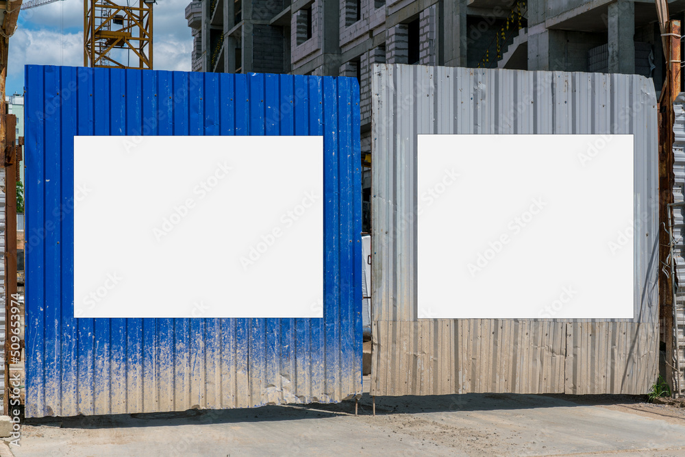 Dual blank sign boards mounted on gate at construction site. Mockup for ...