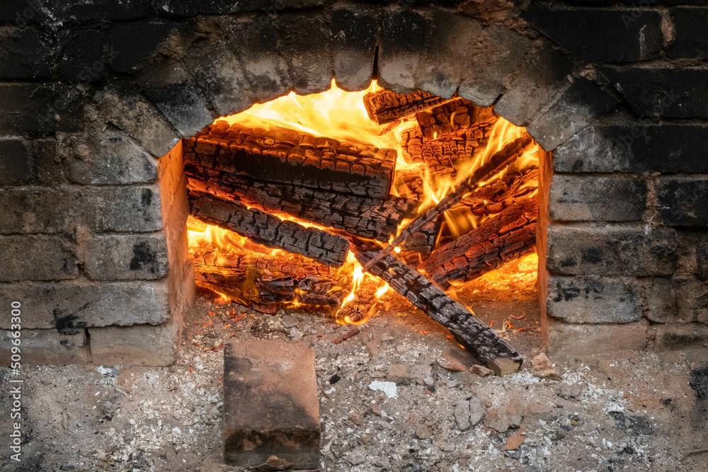 Firing of wood fire kiln is part of process for black pottery. Unique ...