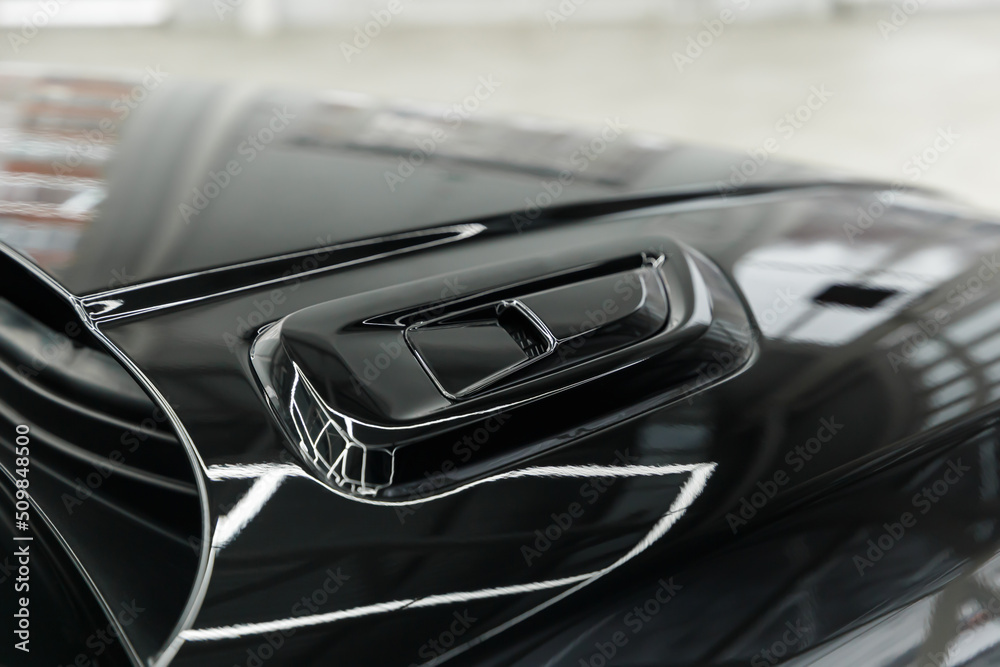 ภาพถ่าย Stock Black air intake on the hood - close-up. The aerodynamic ...