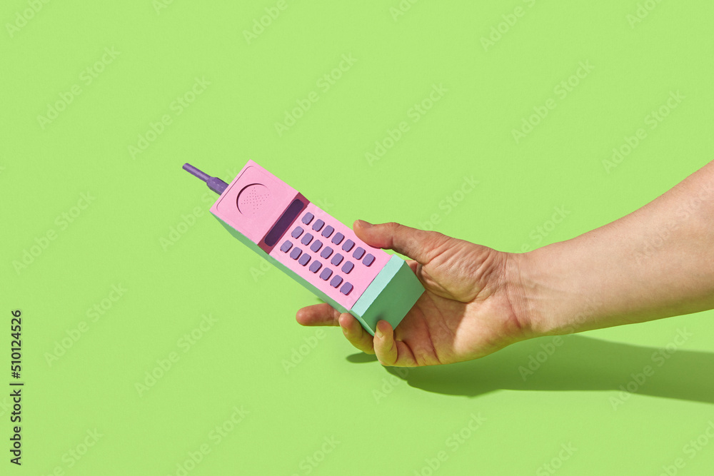 Male hand holding papercraft retro mobile phone Stock Photo | Adobe Stock
