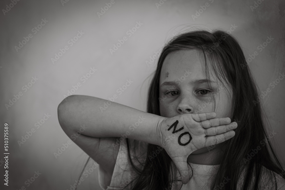 Black and white portrait of little scared bruised girl raising hand to ...