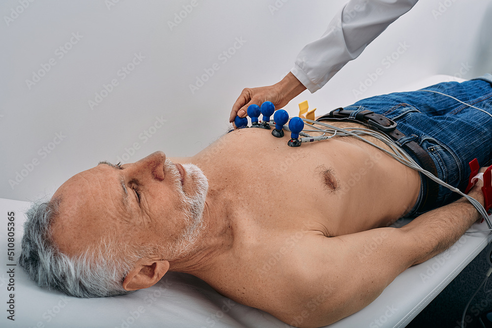 ECG procedure for male patient with electrodes for heart health exam in ...