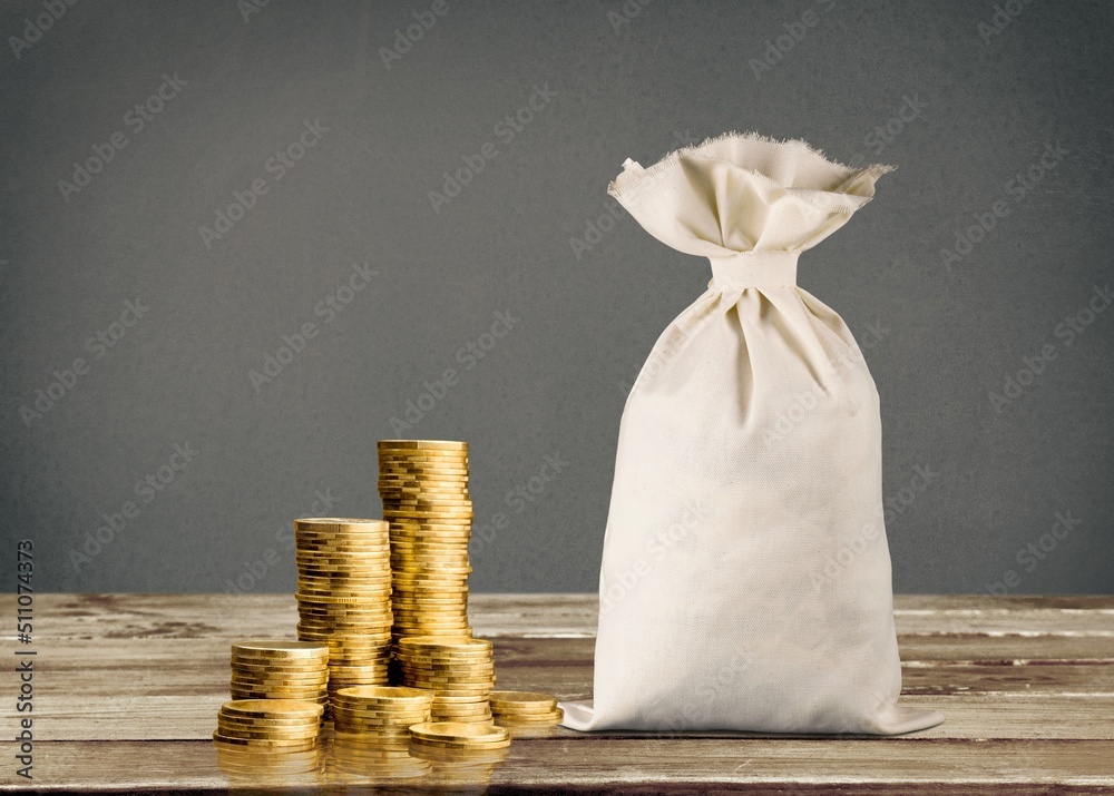 Dollar money bag and increasing stacks of coins. Savings and ...