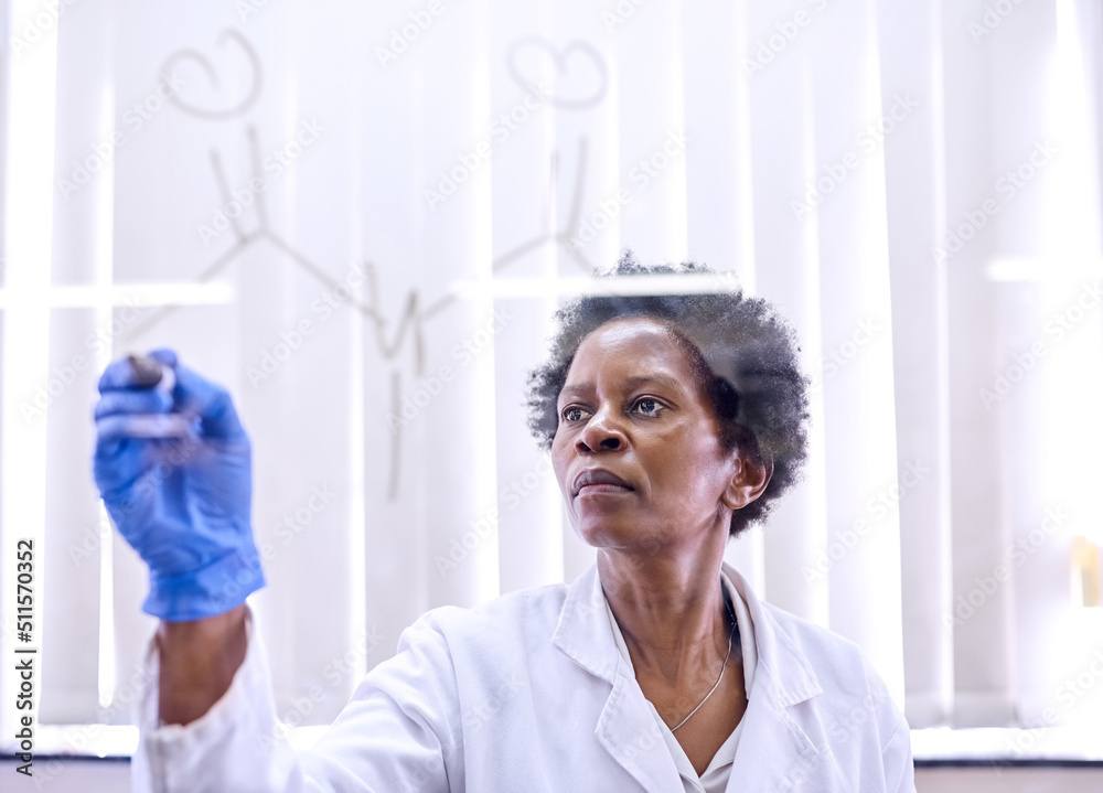 Figuring it all out. Shot of a female scientist drawing molecular ...