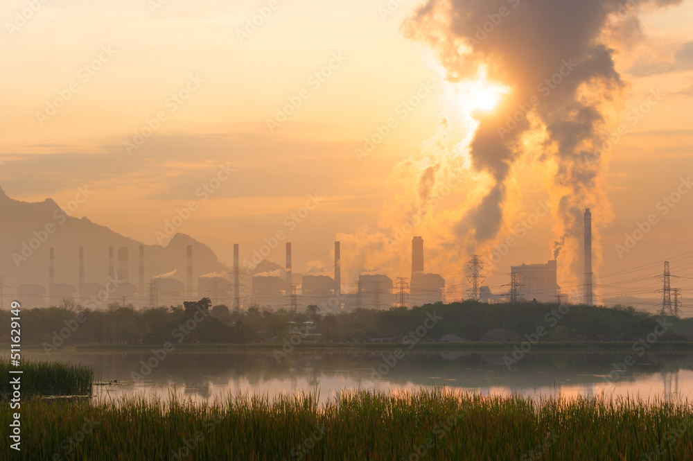 Coal power plant and steam from the flue in the beautiful morning among ...