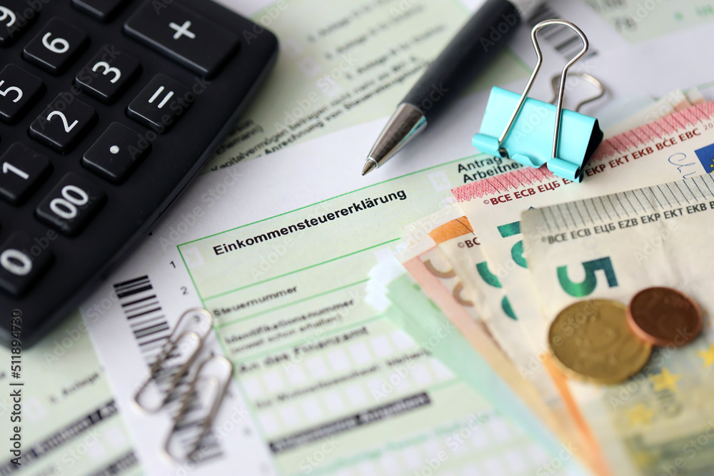 German income tax return form with pen and european euro money bills ...