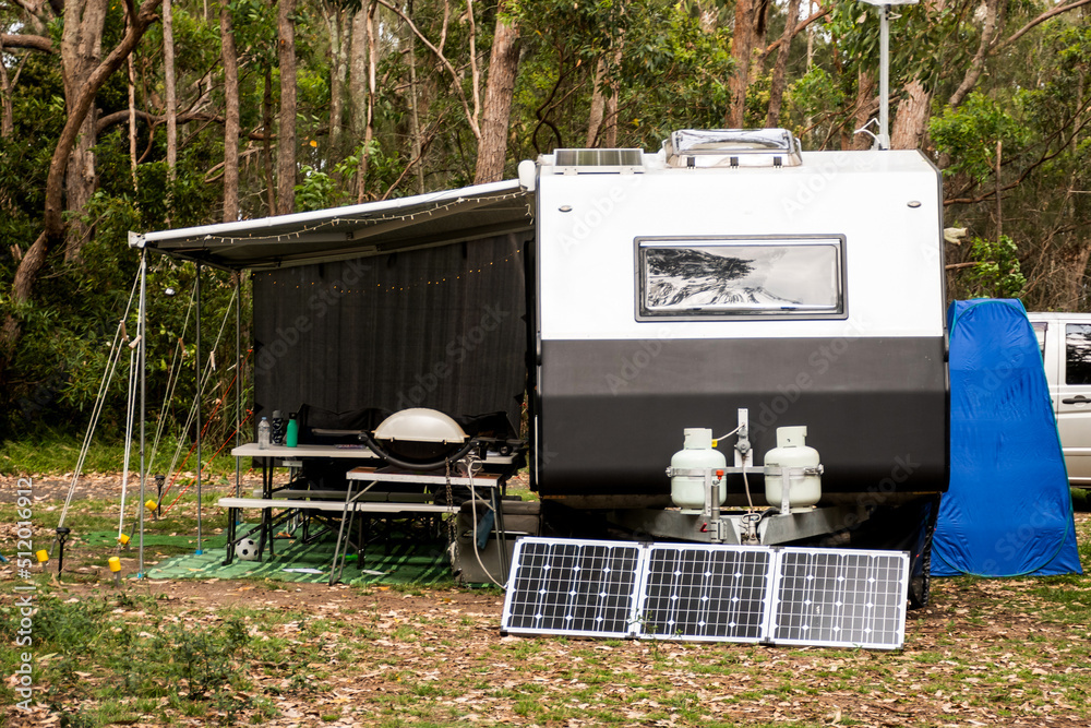 RV caravan camper on a campsite in the bush forest nature. Awning ...