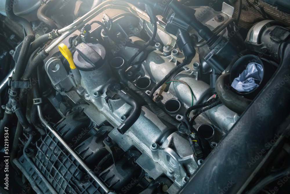 Modern turbo engine in process of changing spark plugs. Interval ...