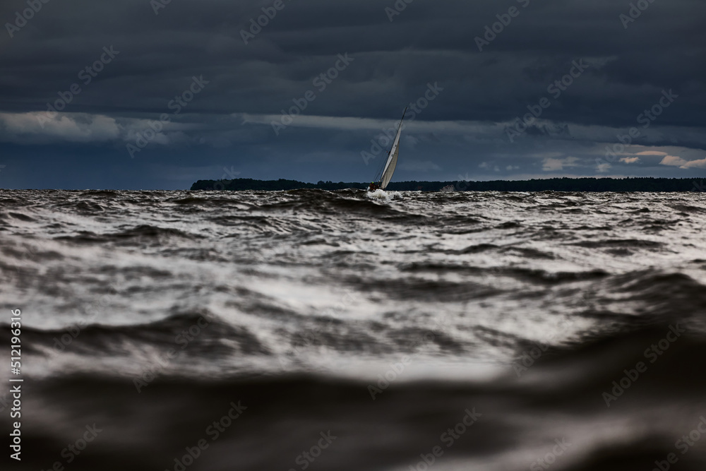 Sailboat in sea at stormy weather, stormy clouds sky orange sky, sail ...