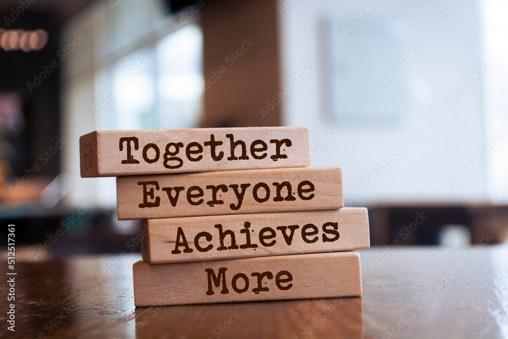 Wooden blocks with the word Together, Everyone, Achieves, More ...