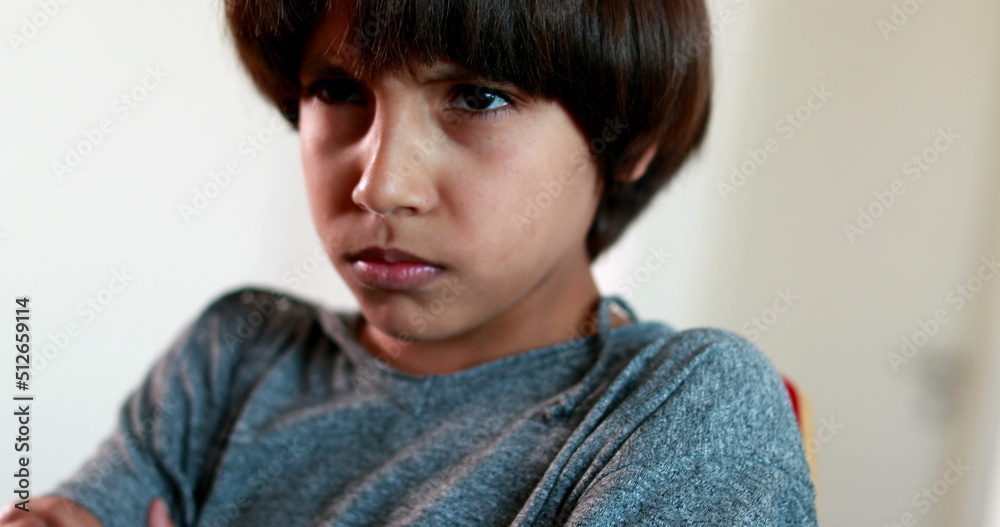 Angry child reaction crossing arms in anger. Offended young boy with ...