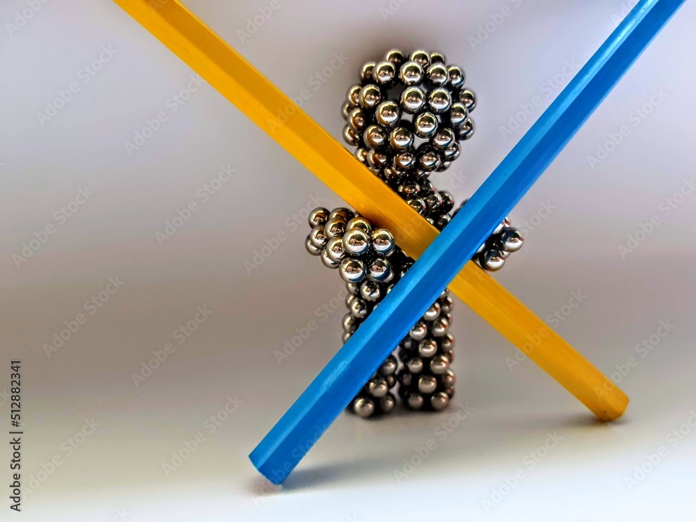 Stock-Foto „Magnetic neocube man figurine holding blue and yellow ...
