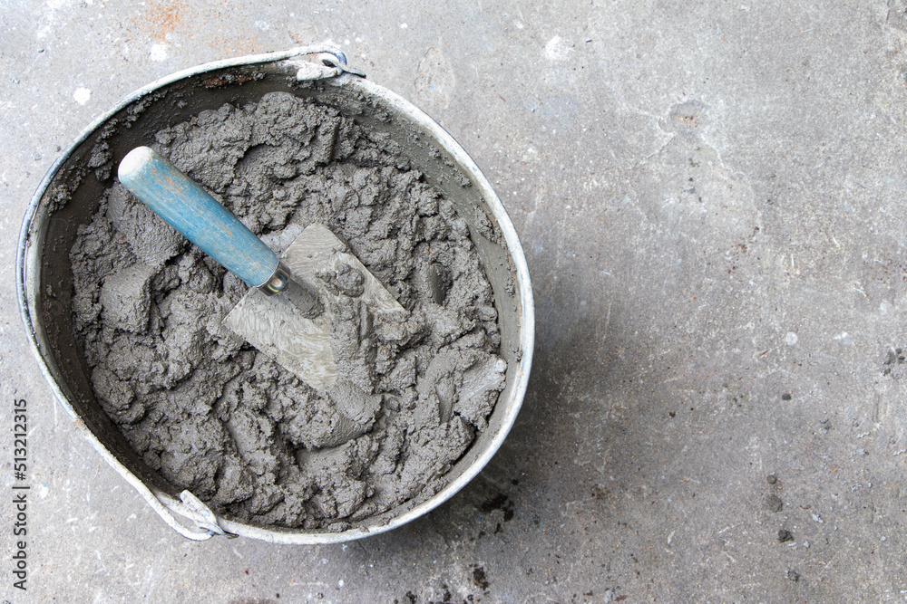Mixing of concrete mortar.The builder prepares the cement mortar using ...