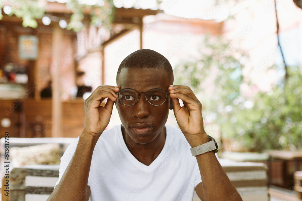 Tired and stressed mix raced, dark skin businessman putting on ...