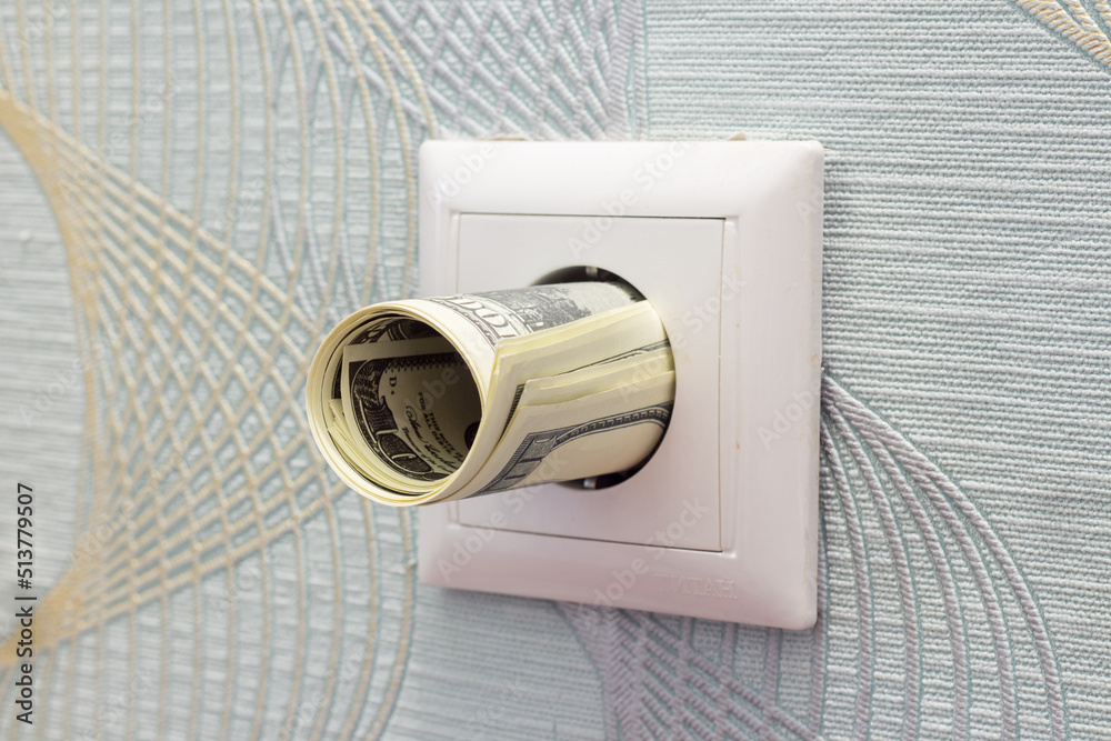 Rolled up banknotes stuck in an electrical outlet. Price increase due ...