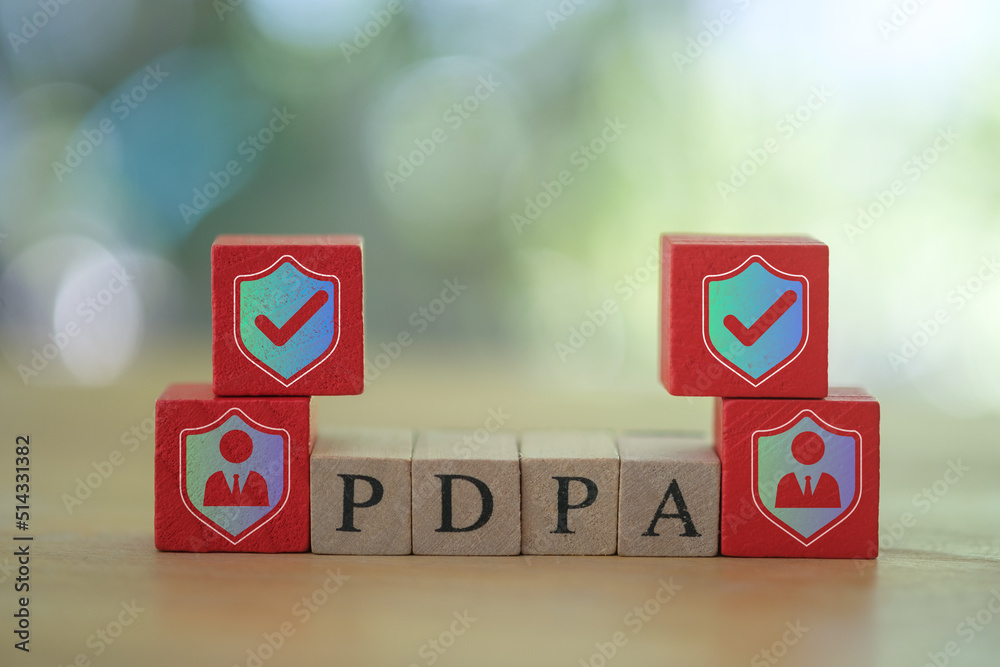 Red wood block with shield icon and human icons with text PDPA ...