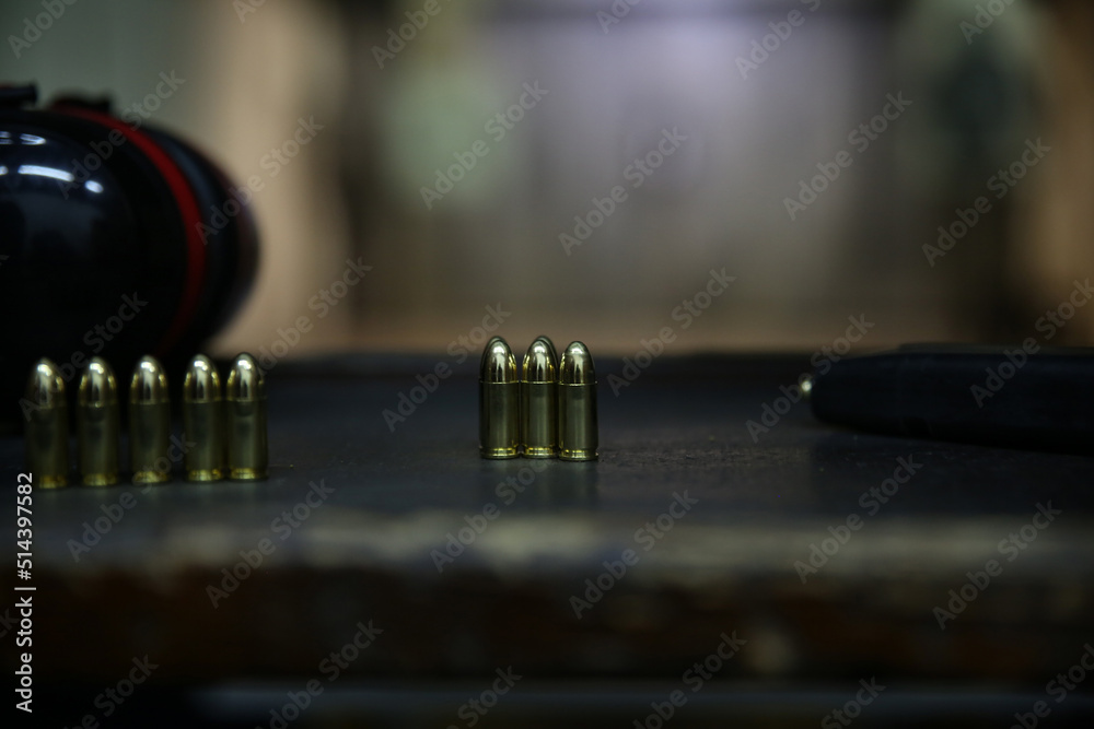Photo Stock Pistol bullets and weapon magazine in a shooting club ...