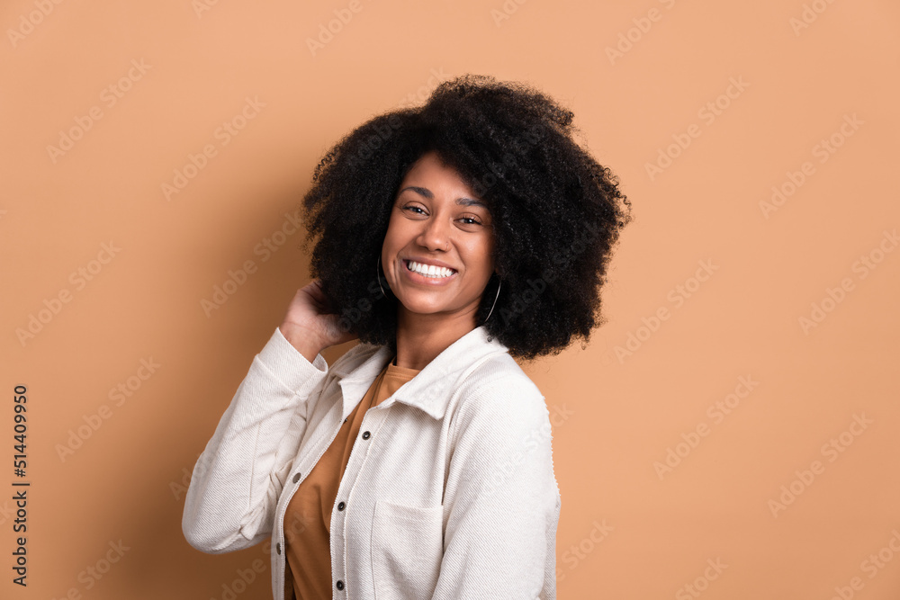 beautiful dark skinned woman touching hair wearing white jacket in ...