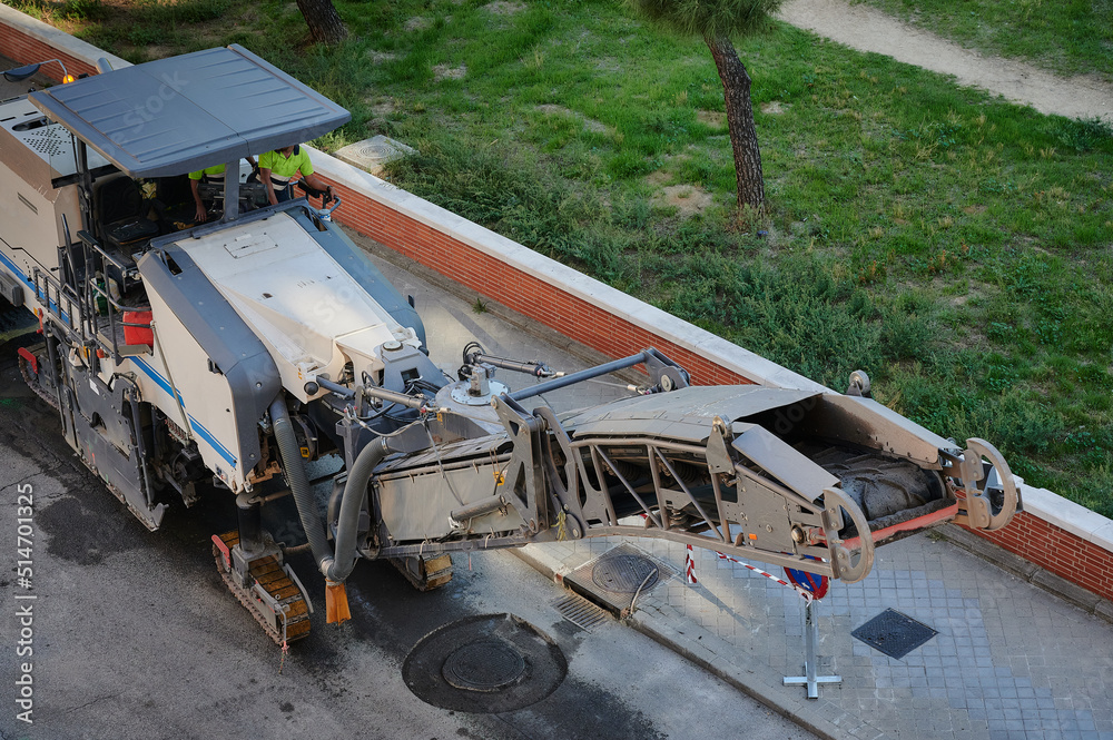 Cold milling machine removing the old asphalt and loading it into a ...