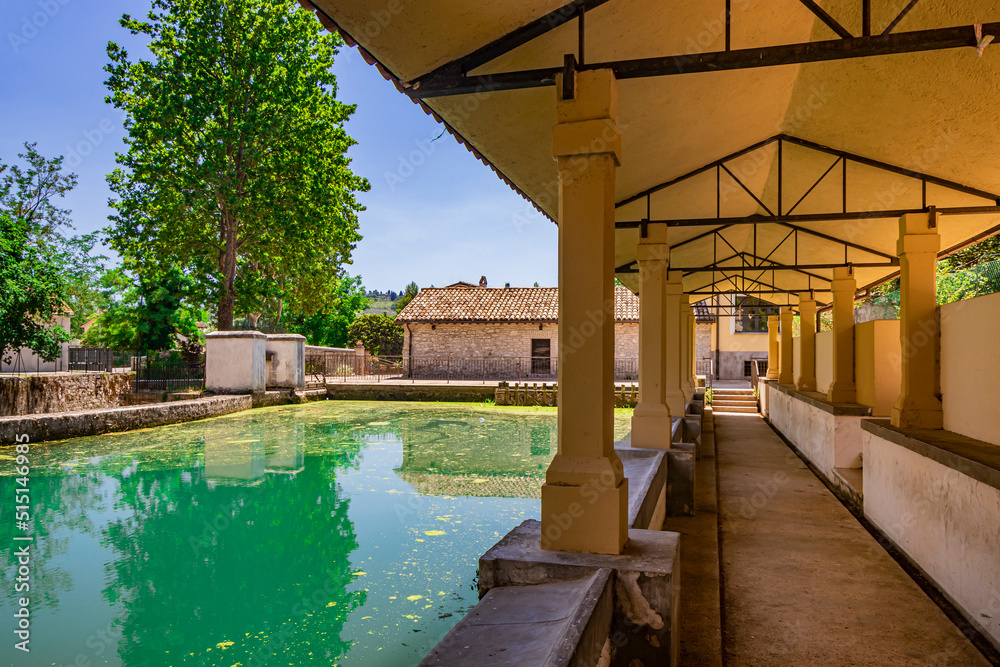 The ancient wash house, on the river, in the medieval village of ...