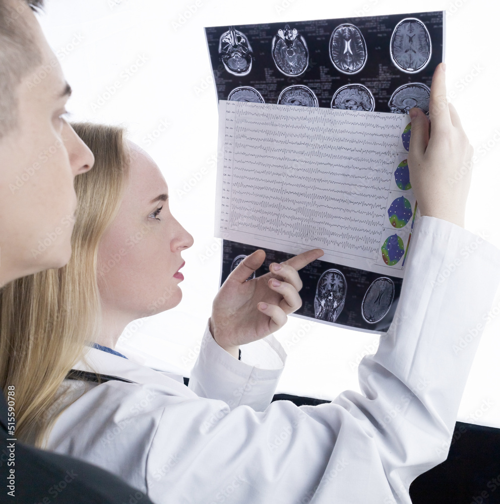 Epileptologist examines patient MRI and electroencephalogram. Concept ...