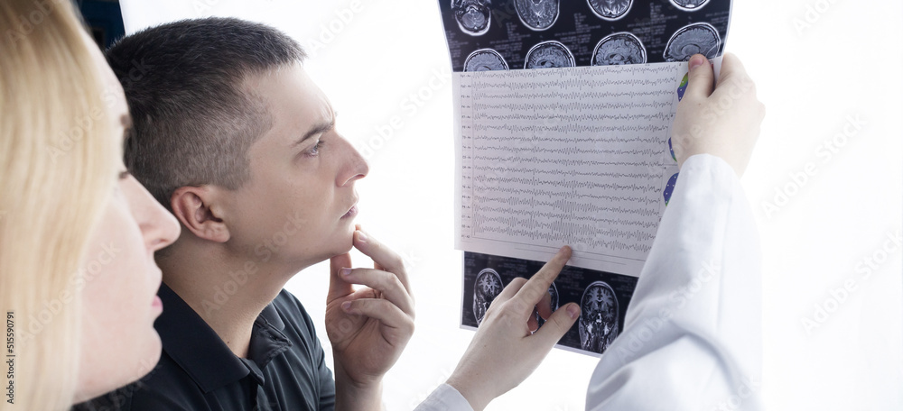 Epileptologist examines patient MRI and electroencephalogram. Concept ...